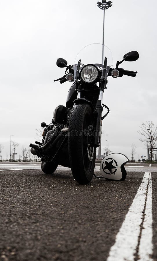 Motorcycle with a Helmet on the Ground beside it Stock Image - Image of ...
