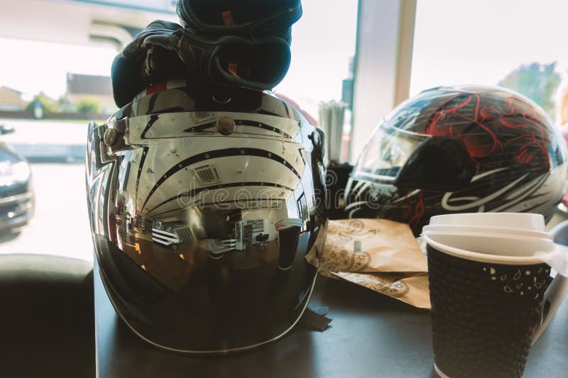 Motorcycle Helmets on a Table in a Roadside Cafe at a Gas Station Stock ...