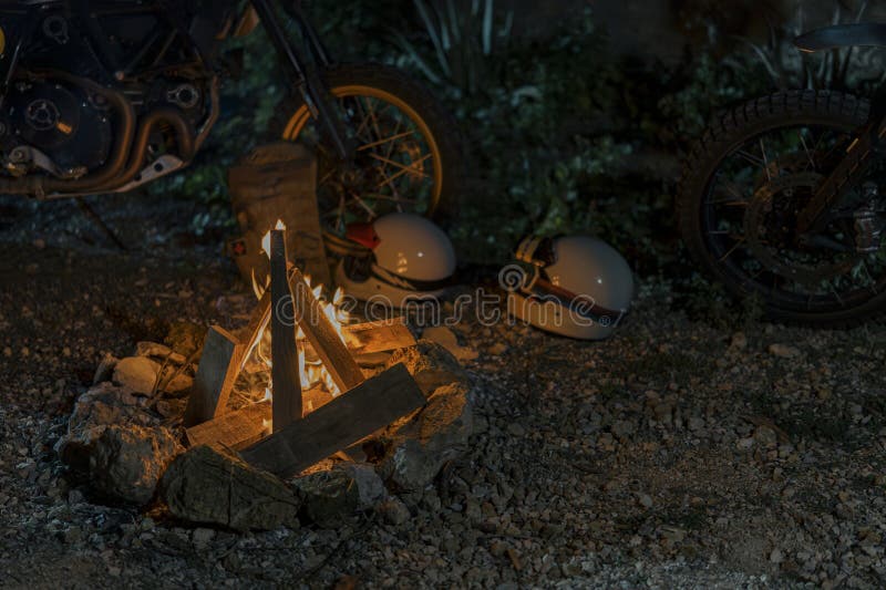 Motorcycle Lights Up the Night by the Fire Outside a Log Stock Image ...