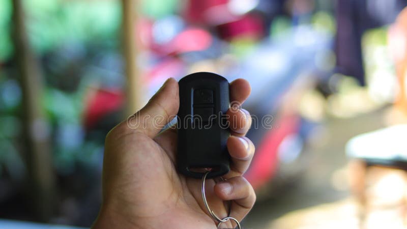 Hand Holding a Motorcycle Key with Blurred Background Stock Photo ...