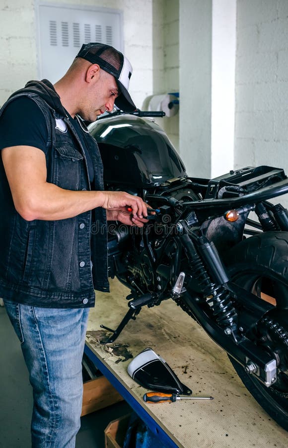 Motorcycle Mechanic Changing a Fuse Stock Photo - Image of fixing, male ...