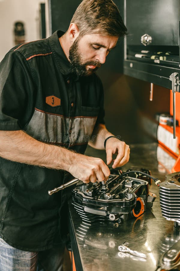 Professional Motorcycle Mechanic Works with Electronics, Cuts Wires ...