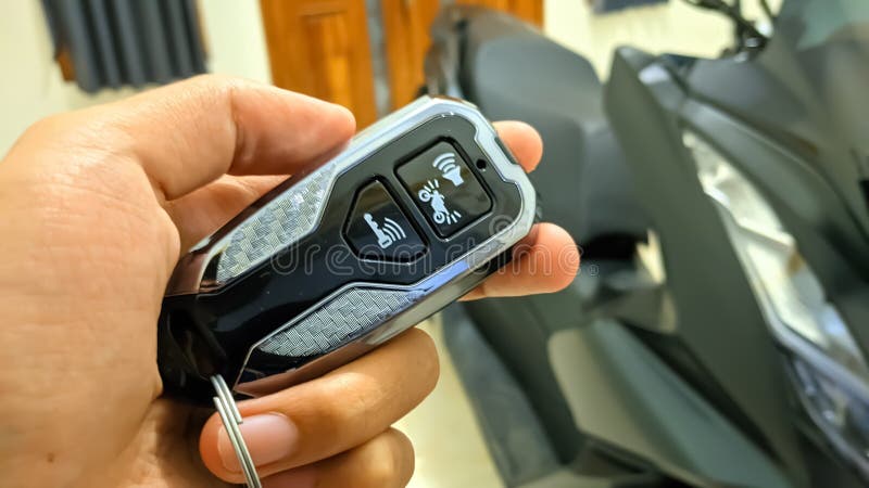 The Motorcycle Owner Holds in His Hand a Remote Control Device for ...