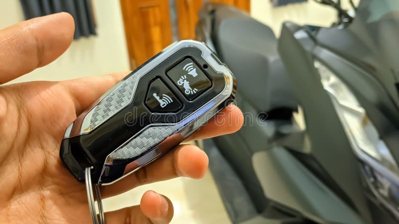 The Motorcycle Owner Holds in His Hand a Remote Control Device for ...