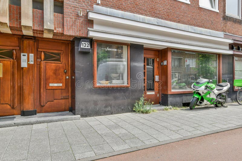 A Motorcycle Parked in Front of a Building Editorial Stock Photo ...