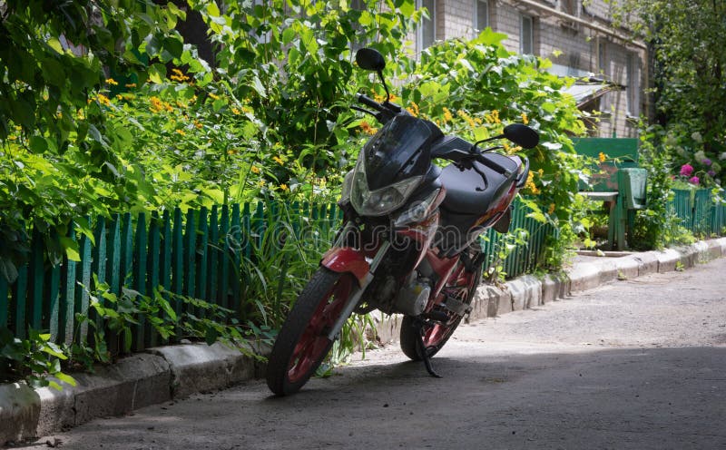 Motorcycle Parked Near the Front Garden of the House. Stock Image ...
