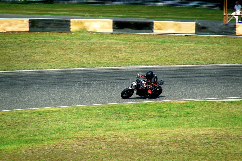 Motorcycle racing on track editorial stock photo. Image of light ...