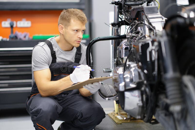 A Motorcycle Repairman Takes Notes, Close-up Stock Image - Image of ...