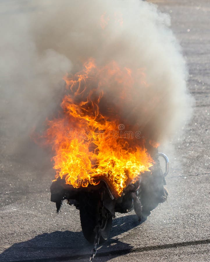 The Motorcycle Rides in Flames of Fire on the Road Stock Photo - Image ...