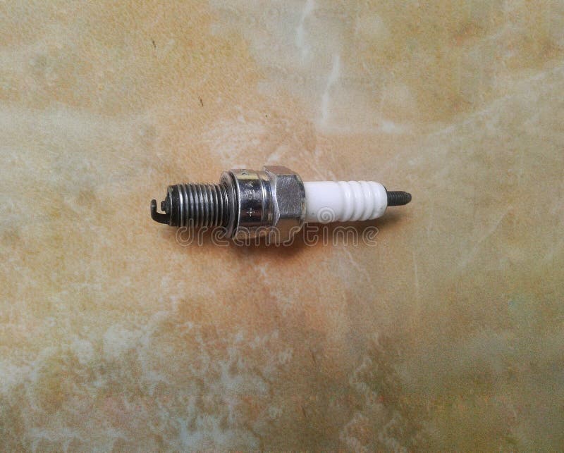 Motorcycle Spark Plugs on the Brown Tile Floor Stock Image - Image of ...