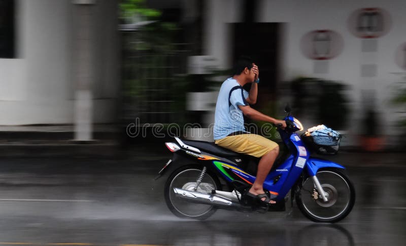 Motorcyclist Covers His Eyes Driving through a Mon Editorial Stock ...