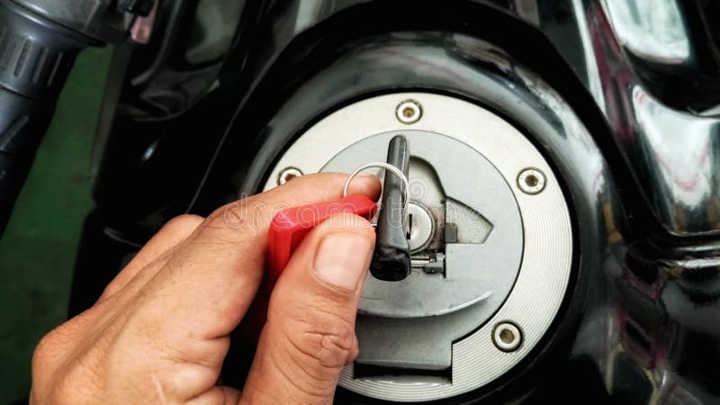 Motorcyclist Inserts Key into Fuel Tank Stock Photo - Image of inserts ...