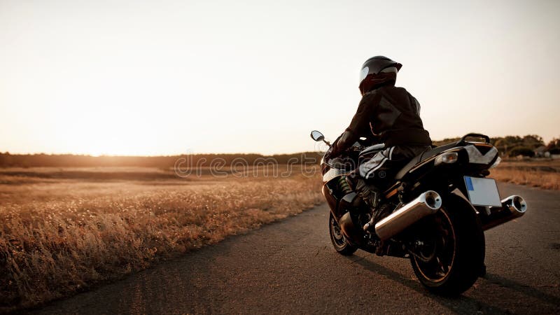 Motorcyclist Turned His Back in Helmet and Gear Against the Backdrop of ...