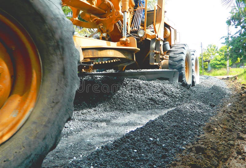 Motorgrader are Adjusted To Smooth the Crushed Rock for Road ...