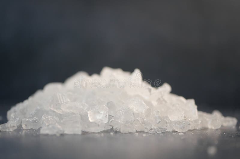 Mound of Crystal Clear Salt Resting on a Dark Surface Stock Photo ...