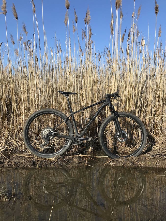 Mountain Bike with Reflection in the Water Stock Photo - Image of ...