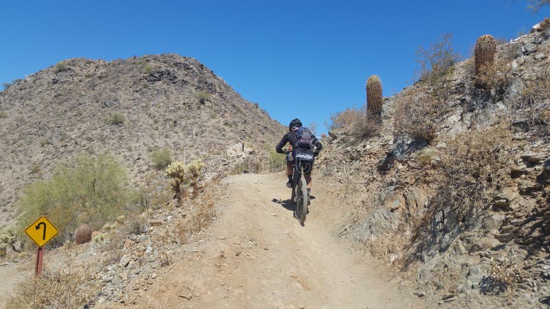 Mountain Biker Riding Uphill in the Desert Editorial Image - Image of ...