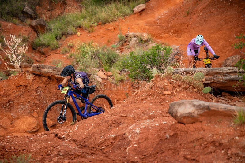 Mountain Bikers Navigating a Challenging Trail with Red Rocks and ...