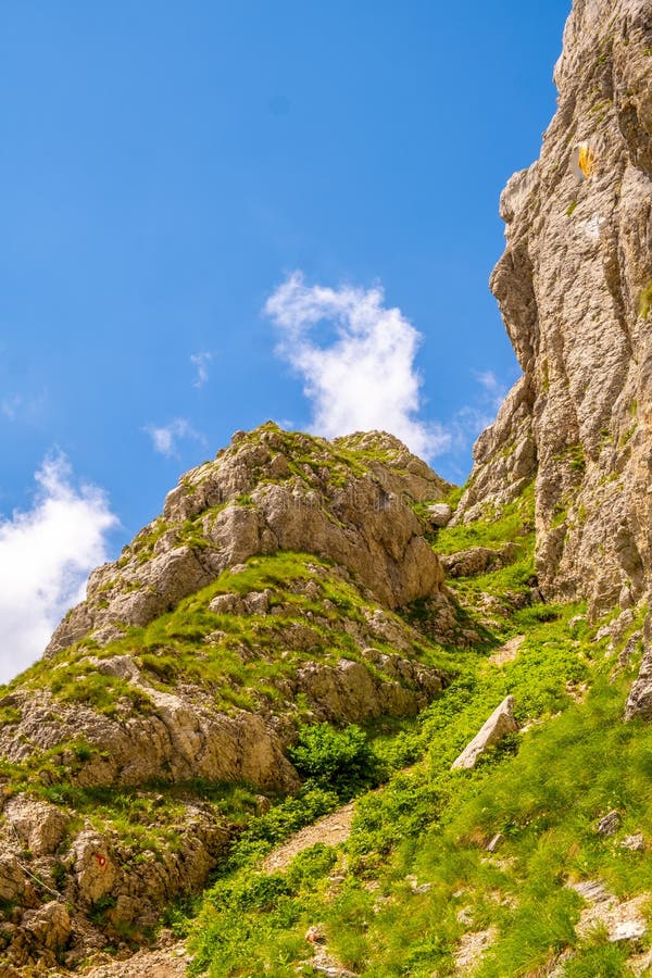Mountain with Grass, Rocks, and Blue Sky in the Background Stock Image ...