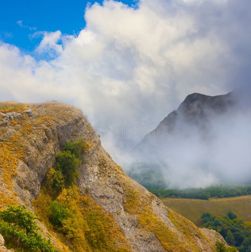 Mountain Chain in Dense Mist Stock Photo - Image of rock, mist: 313813836