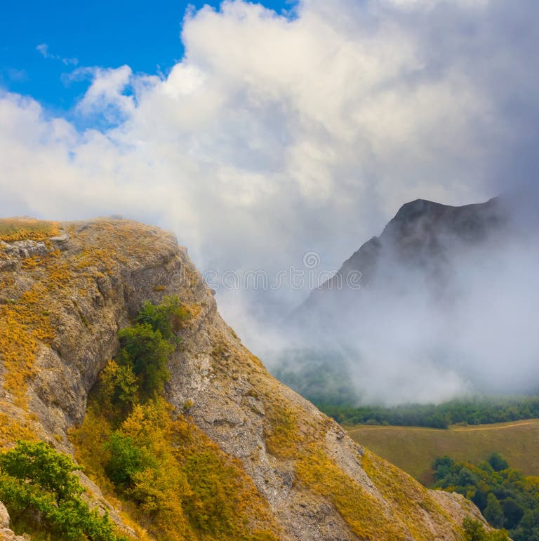 Mountain Chain in Dense Mist Stock Photo - Image of rock, mist: 313813836
