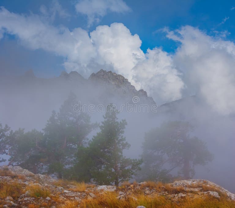 Mountain Chain in Dense Mist Stock Photo - Image of mountain, precipice ...