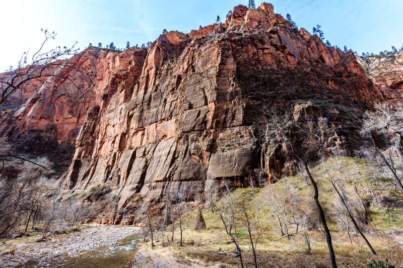 A Mountain with a Cliff Face and a River Running through it Stock Image ...