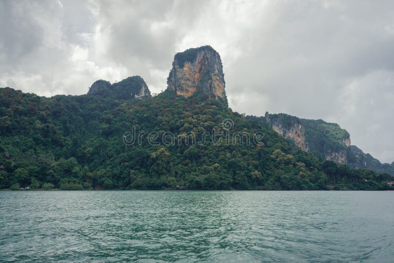Mountain, Cliff and Forest on Sea Shore with Dark Cloudy Sky Stock ...
