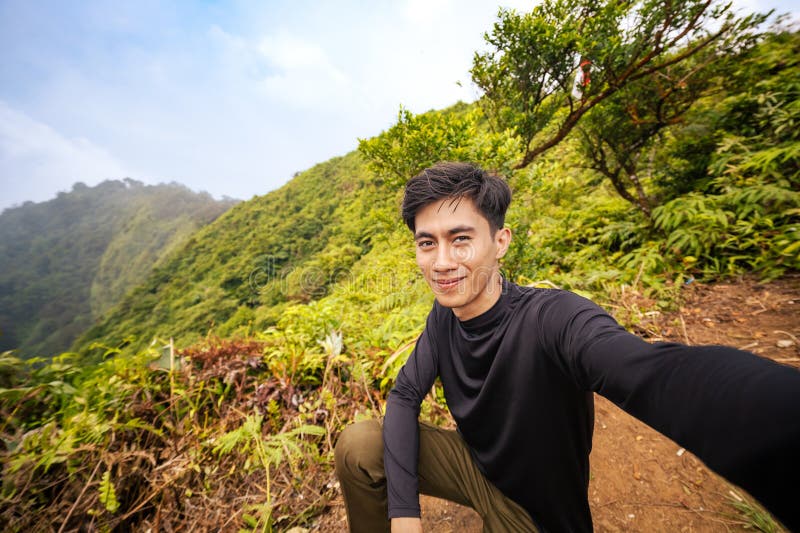 Mountain Climber Facing Camera with Breathtaking View Behind. Majestic ...