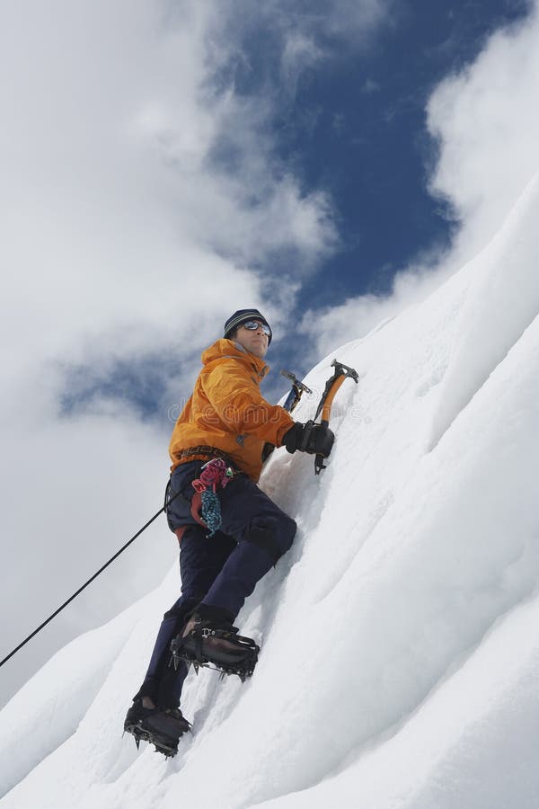 Mountain Climber Going Up Snowy Slope with Axes Stock Photo - Image of ...