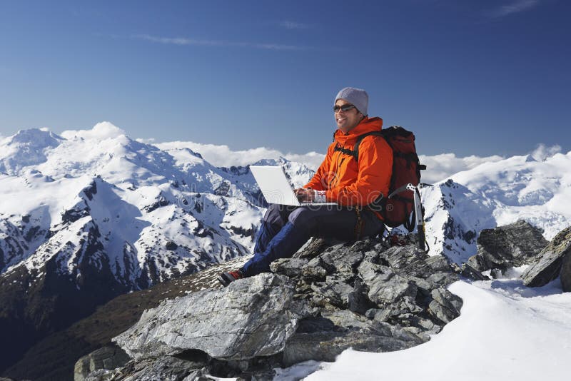 Mountain Climber Using Laptop on Mountain Peak Stock Image - Image of ...