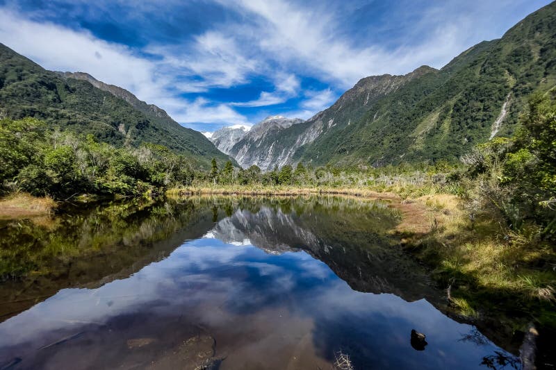Mountain and Cloud Reflections on the Surface of Small Peters Pool in ...