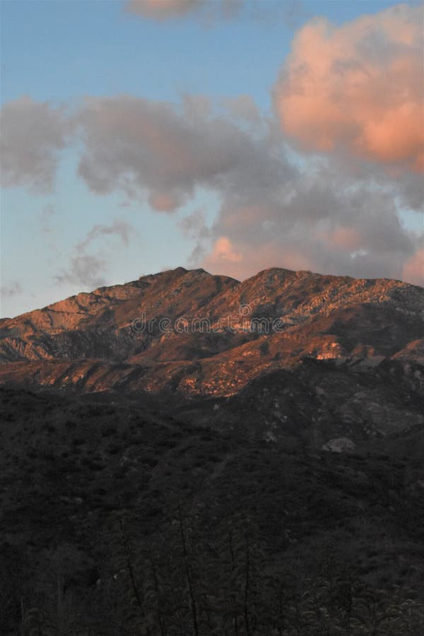 A Mountain with Clouds Changing Color at Sunset. Stock Photo - Image of ...