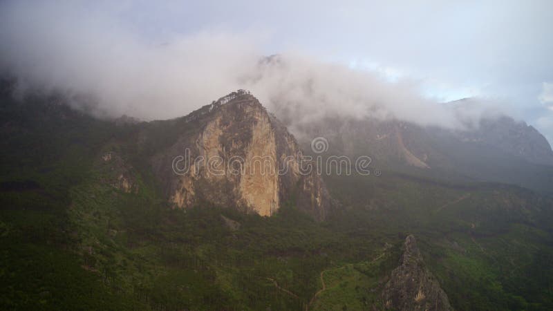 Majestic Peaks Hidden in Mysterious Mist and Brooding Clouds Stock ...