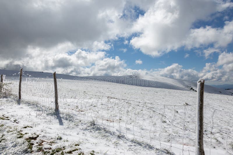 Mountain Fields Covered by Snow, with a Fence in the Foreground ...