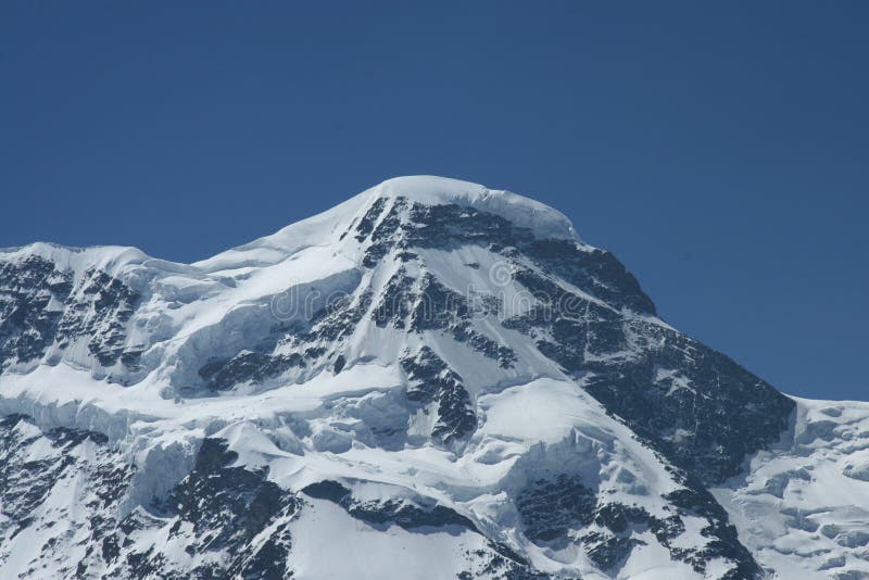 Mountain Head stock image. Image of switzerland, blue, snow - 902153