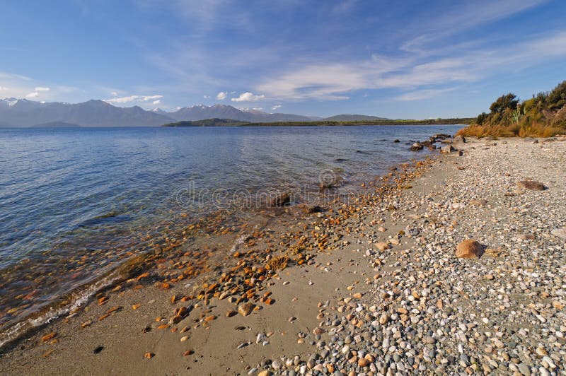 Mountain Lake with a Pebble Beach Stock Image - Image of blue ...