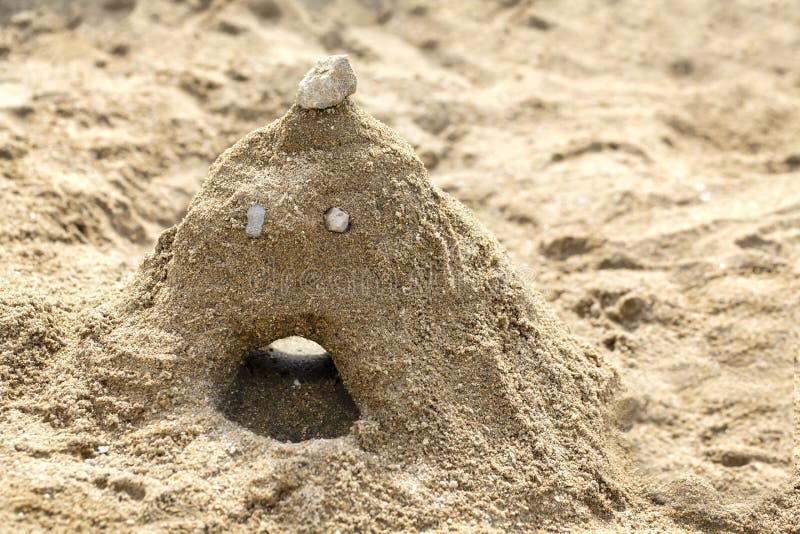 A Mountain Made of the Sand with the Face Made by Kids in Sandbox on a ...