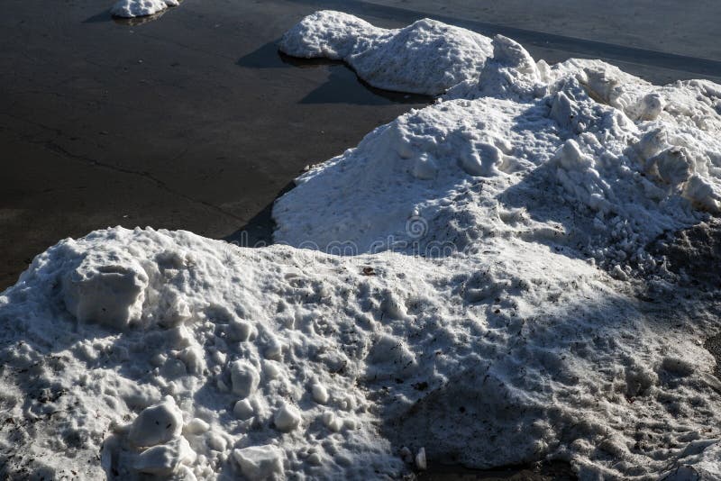 Mountain of Melting Snow Under the Sun on the Asphalt Stock Image ...