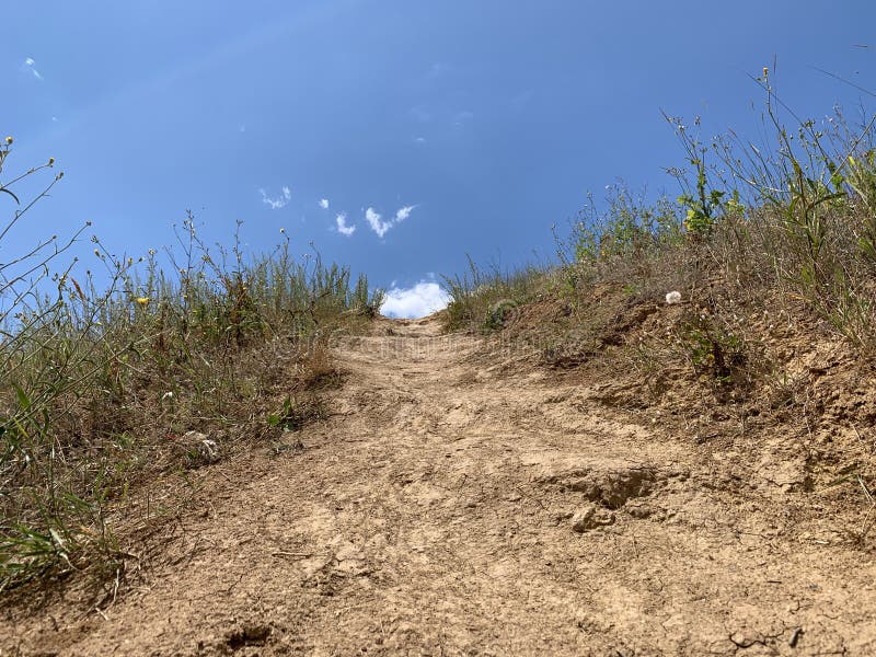 Mountain Path Against the Blue Sky. Climbing among Stones and Grass ... Mountain Path Against the Blue Sky. Climbing among Stones and Grass ...