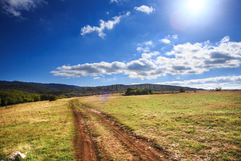 Mountain Path Leads through Plain with Beautiful Scenic Mountain Stock ...