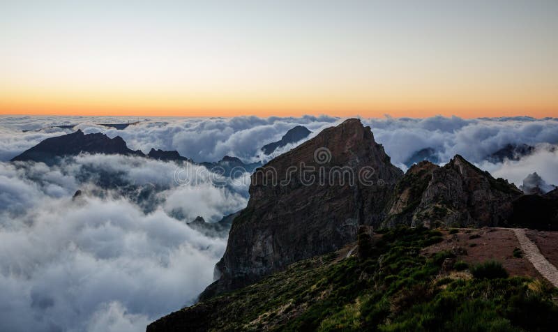Mountain Pinnacles at Sunset. Clouds Below the Peaks. Stock Image ...