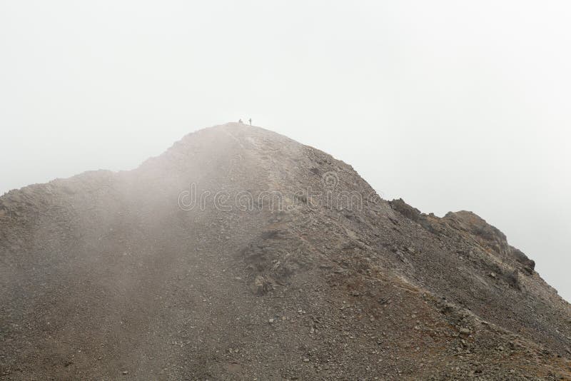 Mountain Range in the Clouds. Two People are Walking Along the Ridge ...