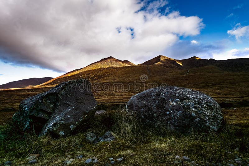 Mountain Range Dominates the Landscape. Two Boulders Rest in the ...