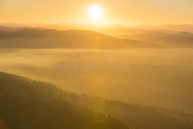 Mountain Range with Fog with the Sun Setting Stock Image - Image of ...