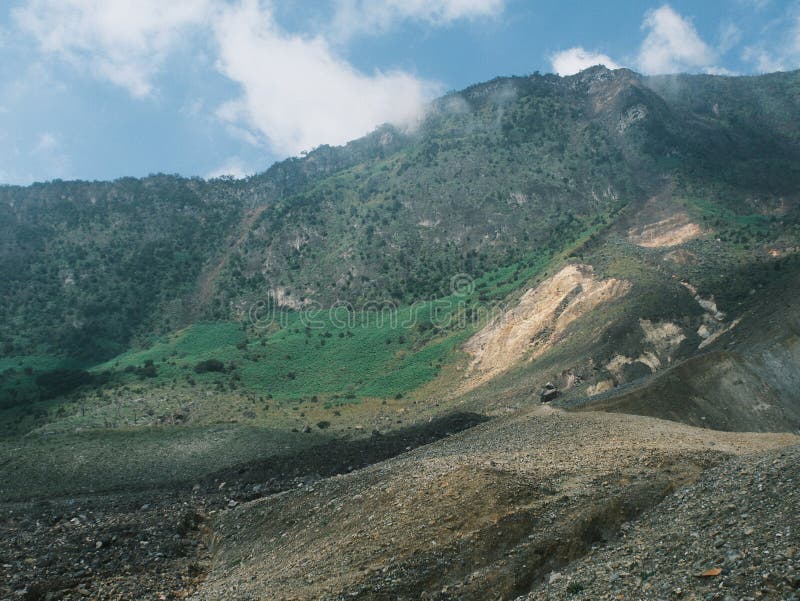 A Mountain Range with a Green Hillside and a Rocky, Barren Hillside ...