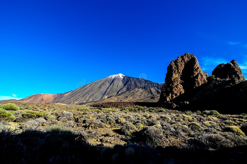 A Mountain Range with a Large Rock in the Foreground Stock Image ...