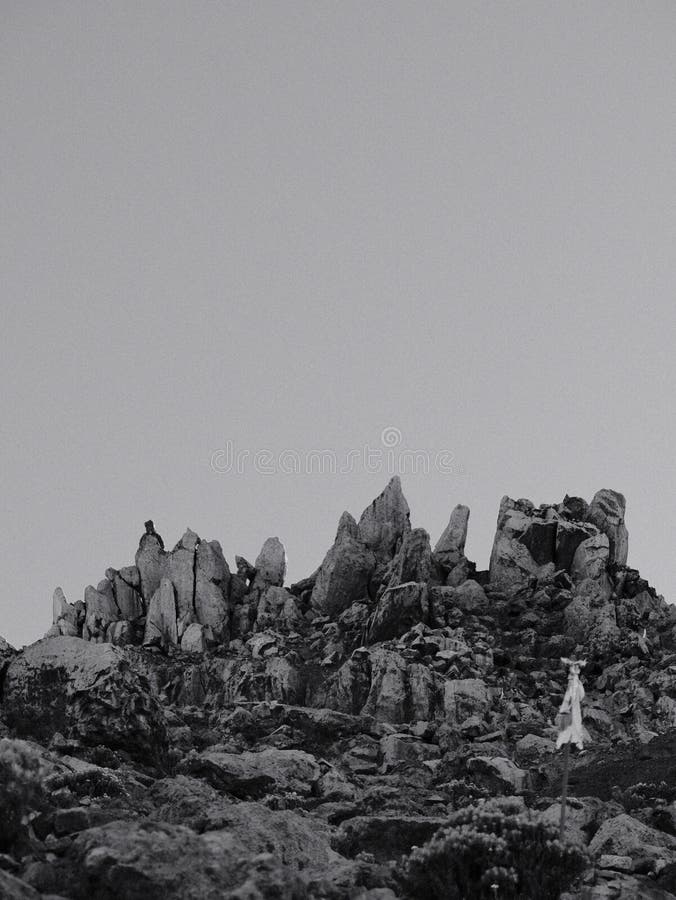 A Mountain Range with a Lone Person Standing on Top of it Stock Photo ...