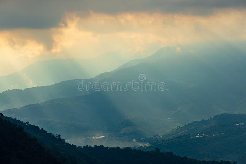 Mountain Range in the Morning with Clouds and Light Shining Down Stock ...