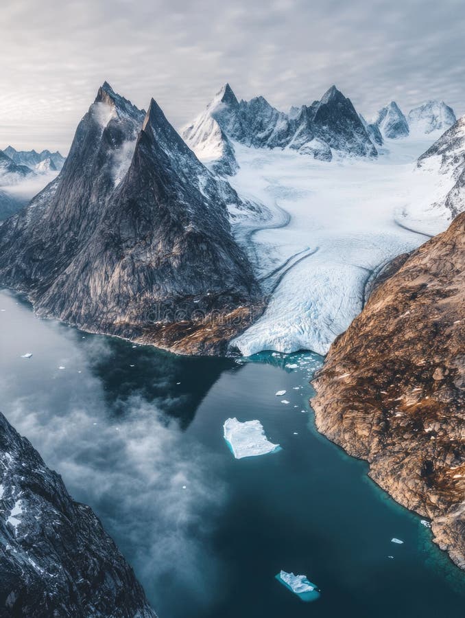 A Mountain Range with Snow Capped Peaks and a River with Ice Floating ...
